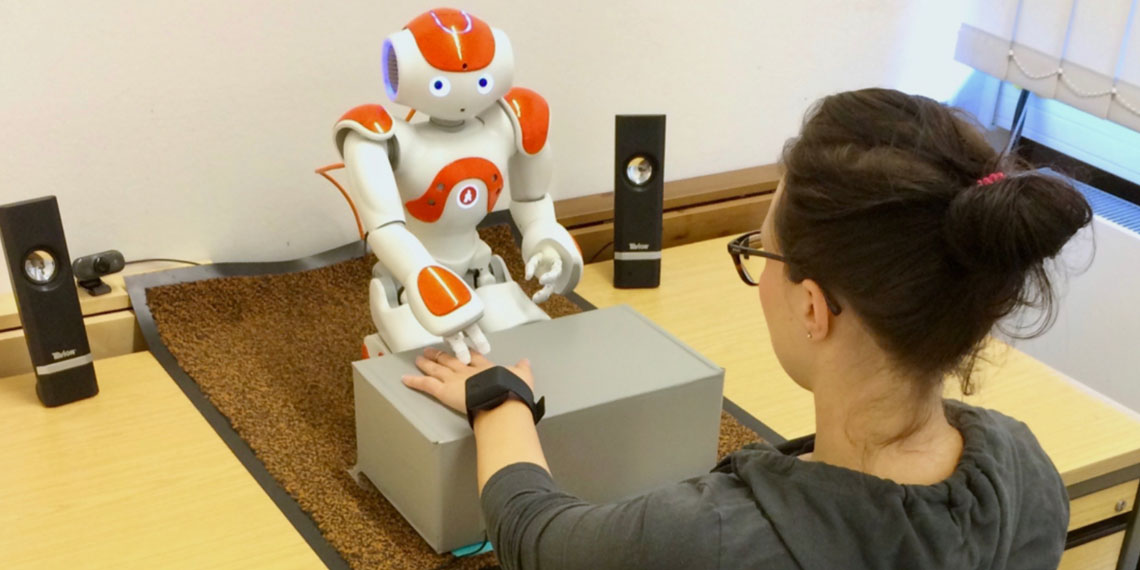 A pat on the hand from a humanoid robot boosts positive feelings and ...